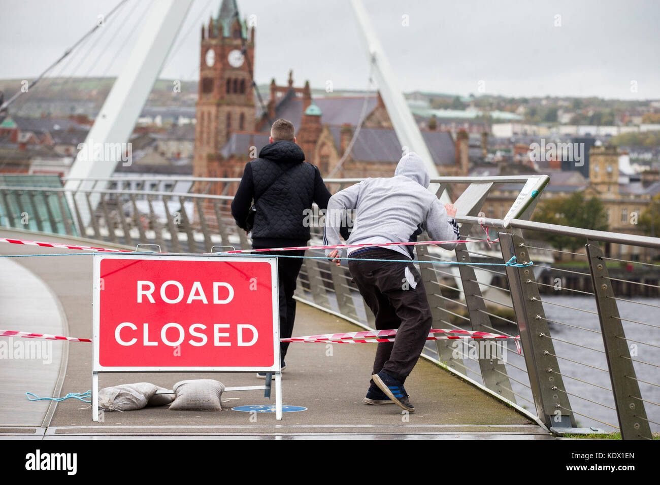 Two young men ignore the closure sign on the Peace Bridge in ...