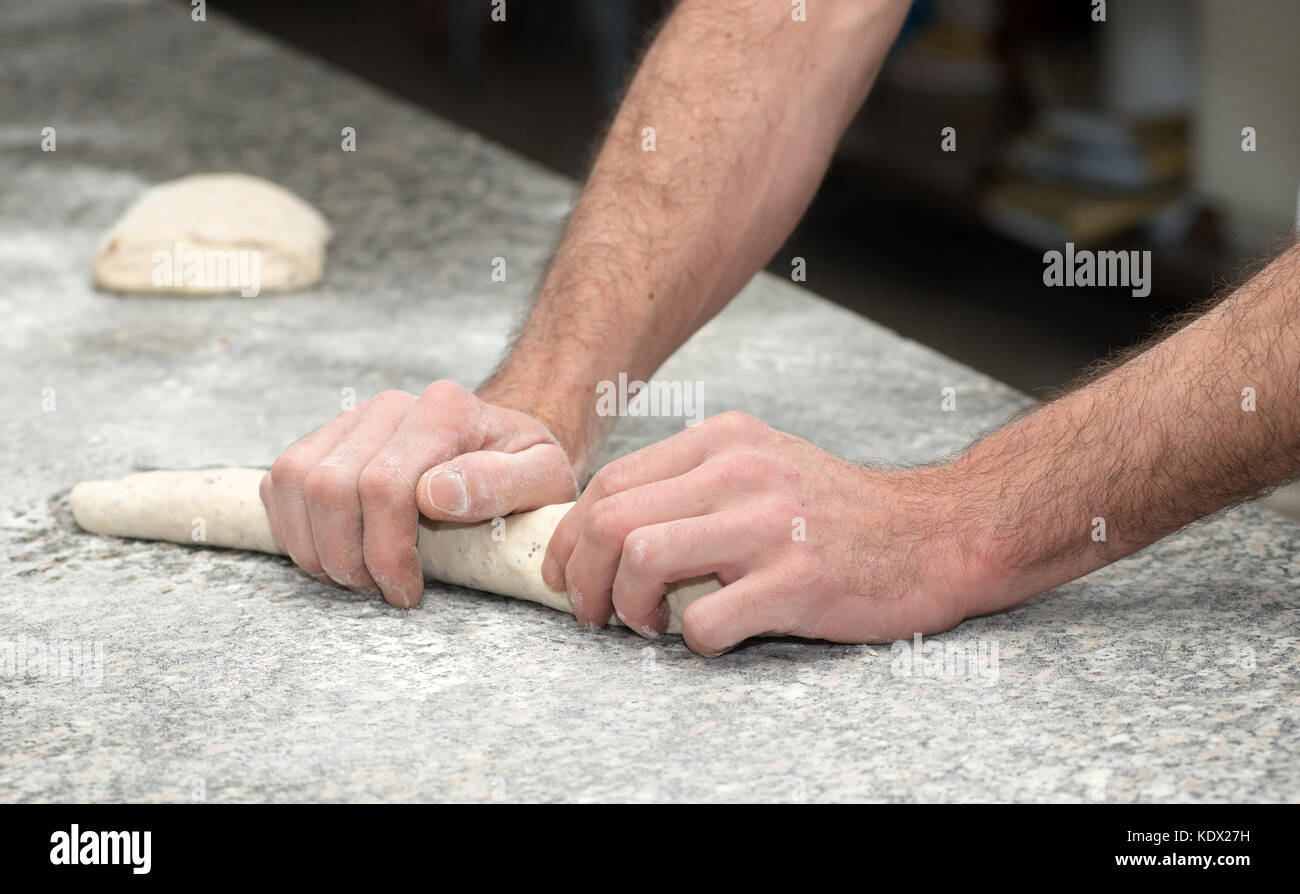 the baker prepares bread dough, close up on his hands Stock Photo - Alamy