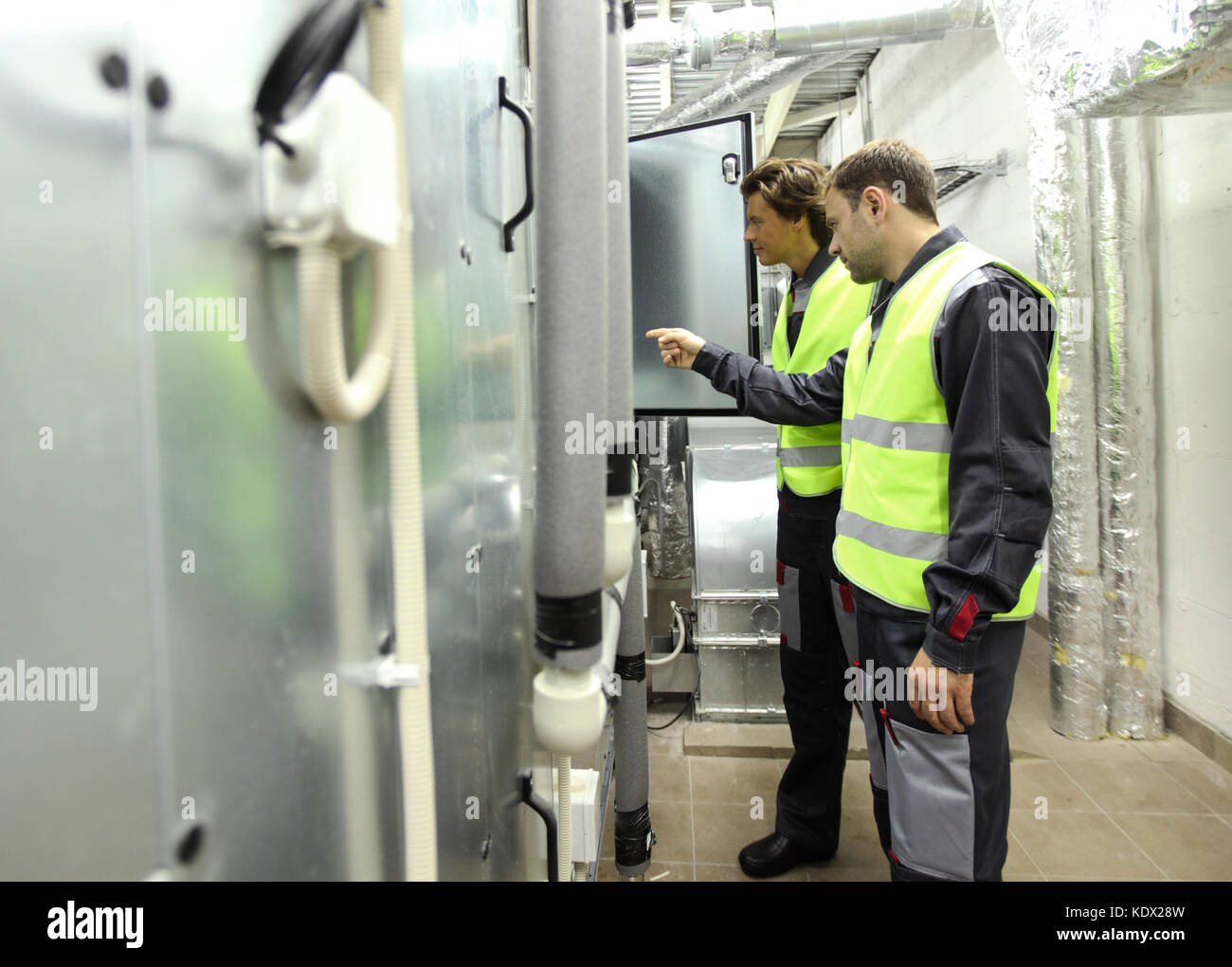 Workers in electrical switchgear room of CNC plant Stock Photo - Alamy