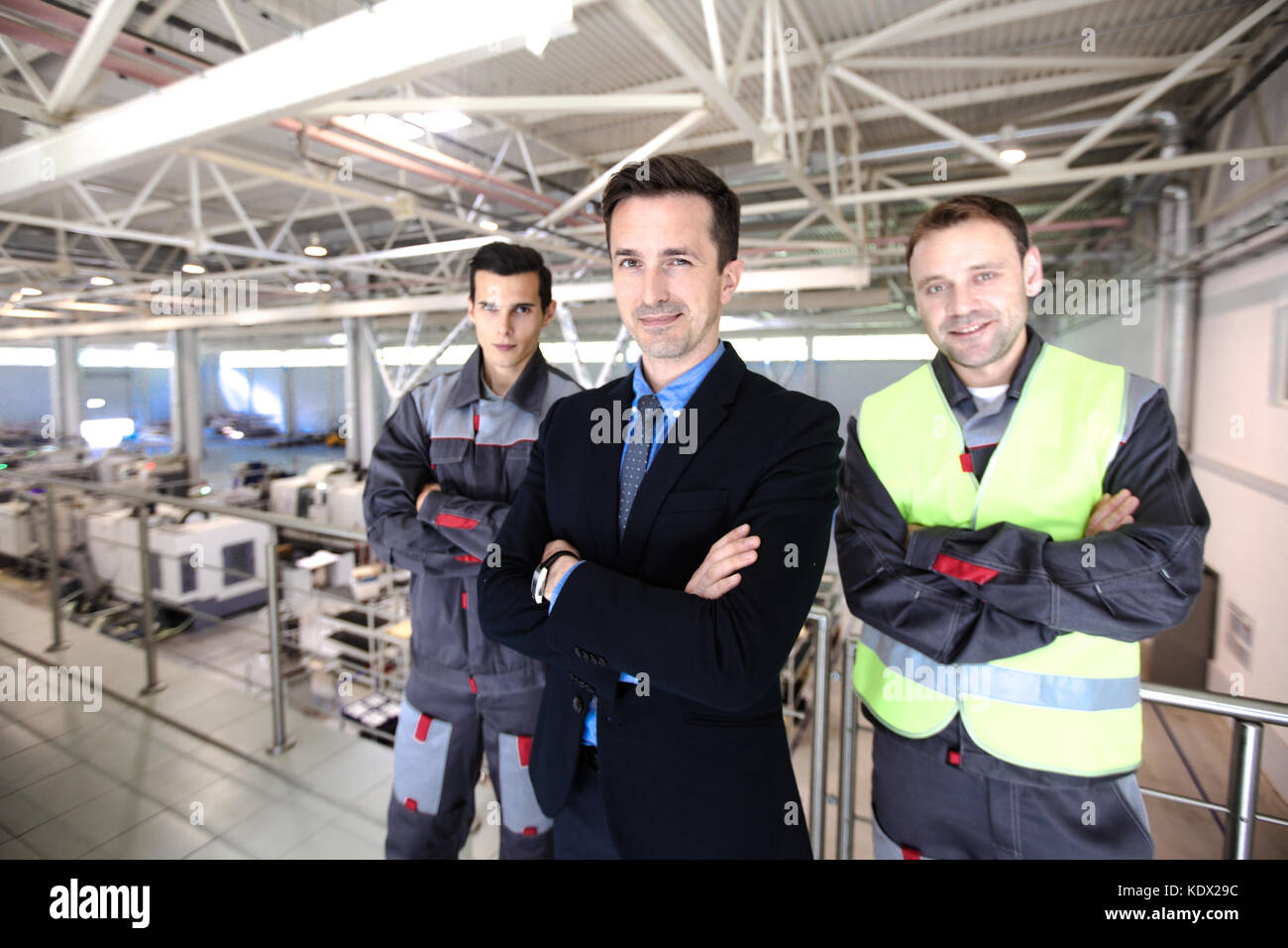 Team of manager and two workers in CNC factory Stock Photo - Alamy