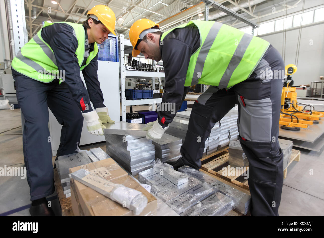 Workers taking aluminium billet at CNC machine shop Stock Photo - Alamy