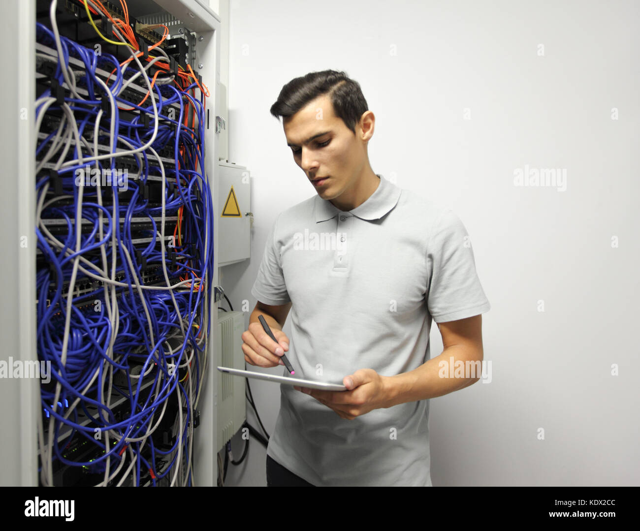 Young engeneer man in network server room with digital tablet Stock ...