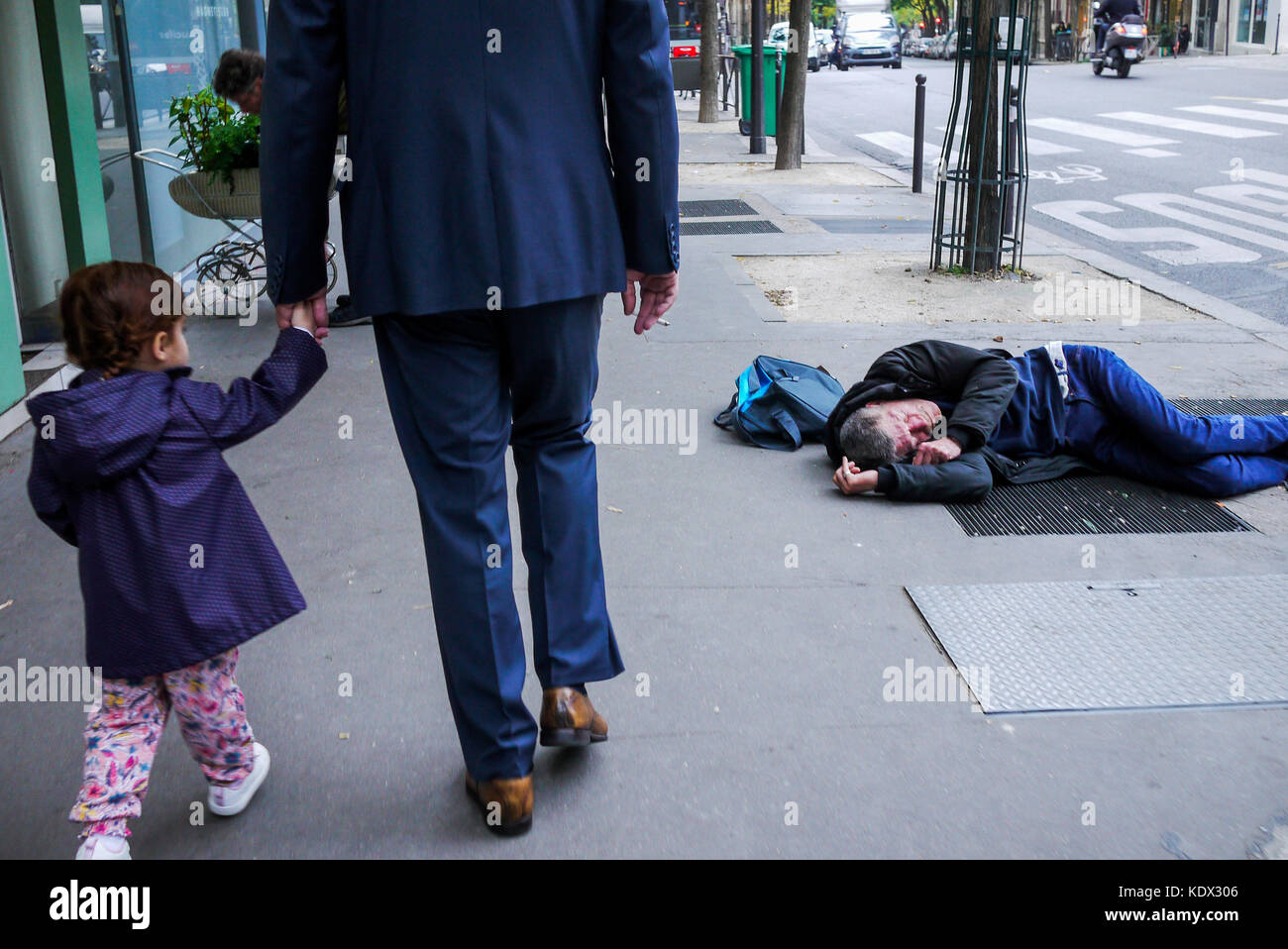 Homeless person lays on a footpath in Paris, France Stock Photo - Alamy