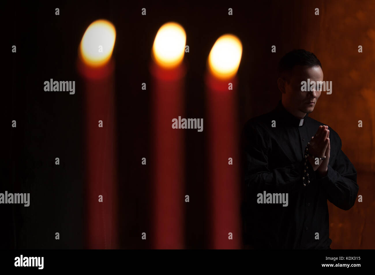 Portrait of handsome catholic priest or pastor with dog collar, dark ...