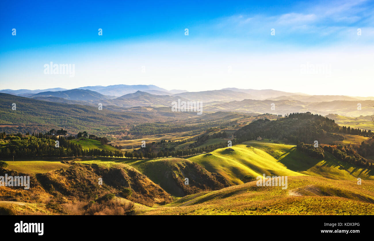 Volterra winter panorama, rolling hills and green fields on sunset ...