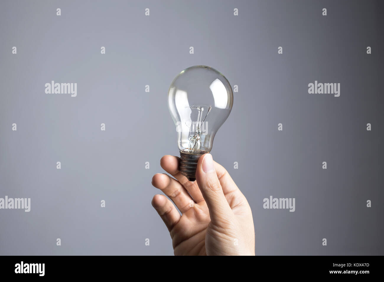 hand holding a bulb Stock Photo - Alamy