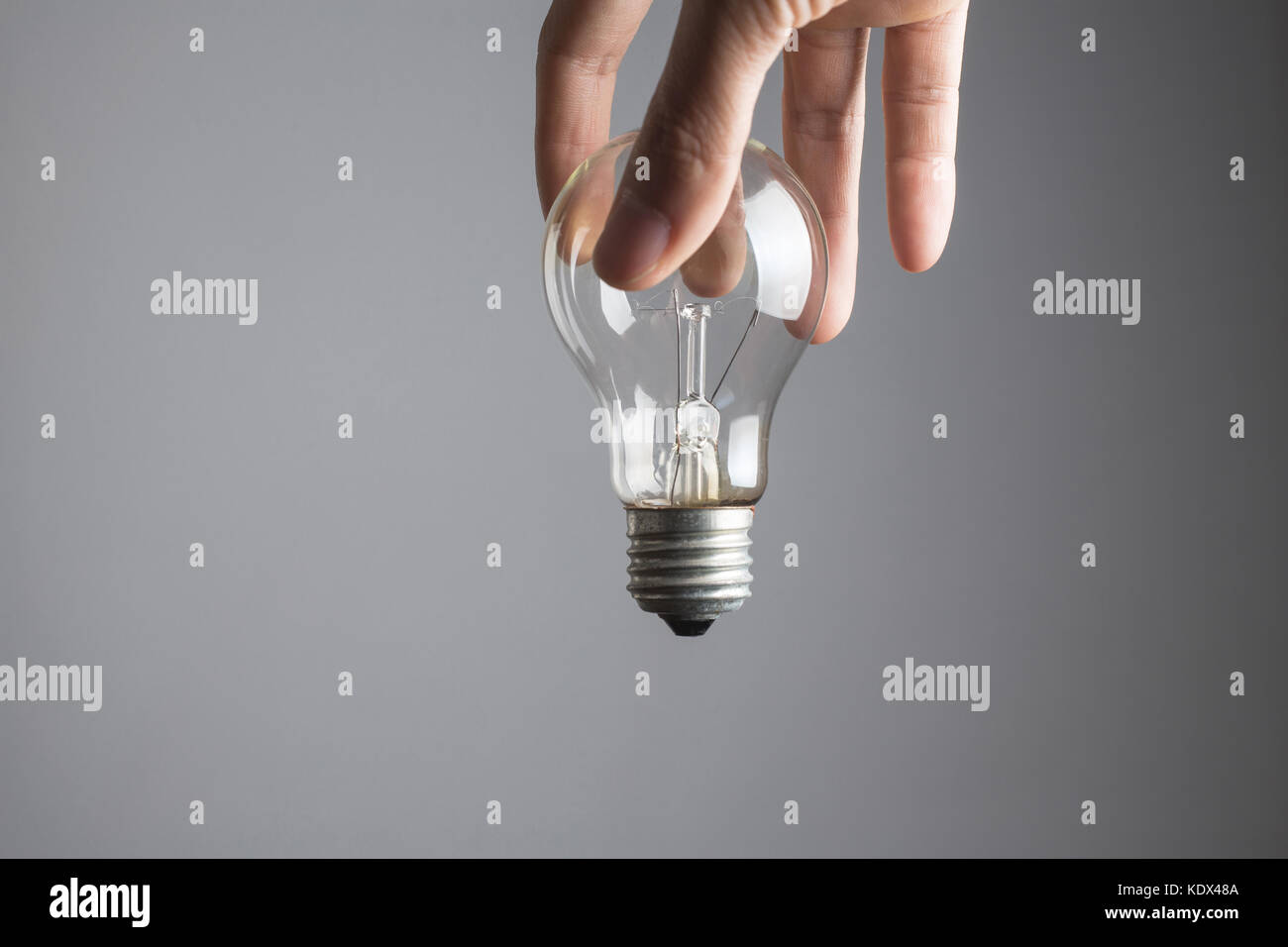 hand holding a bulb Stock Photo - Alamy