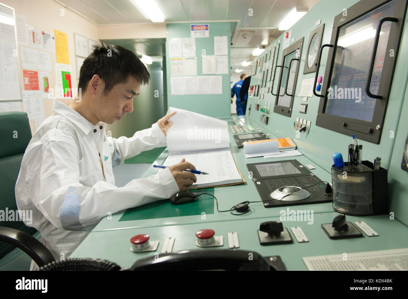 Ship's engineering officer in engine control room Stock Photo - Alamy