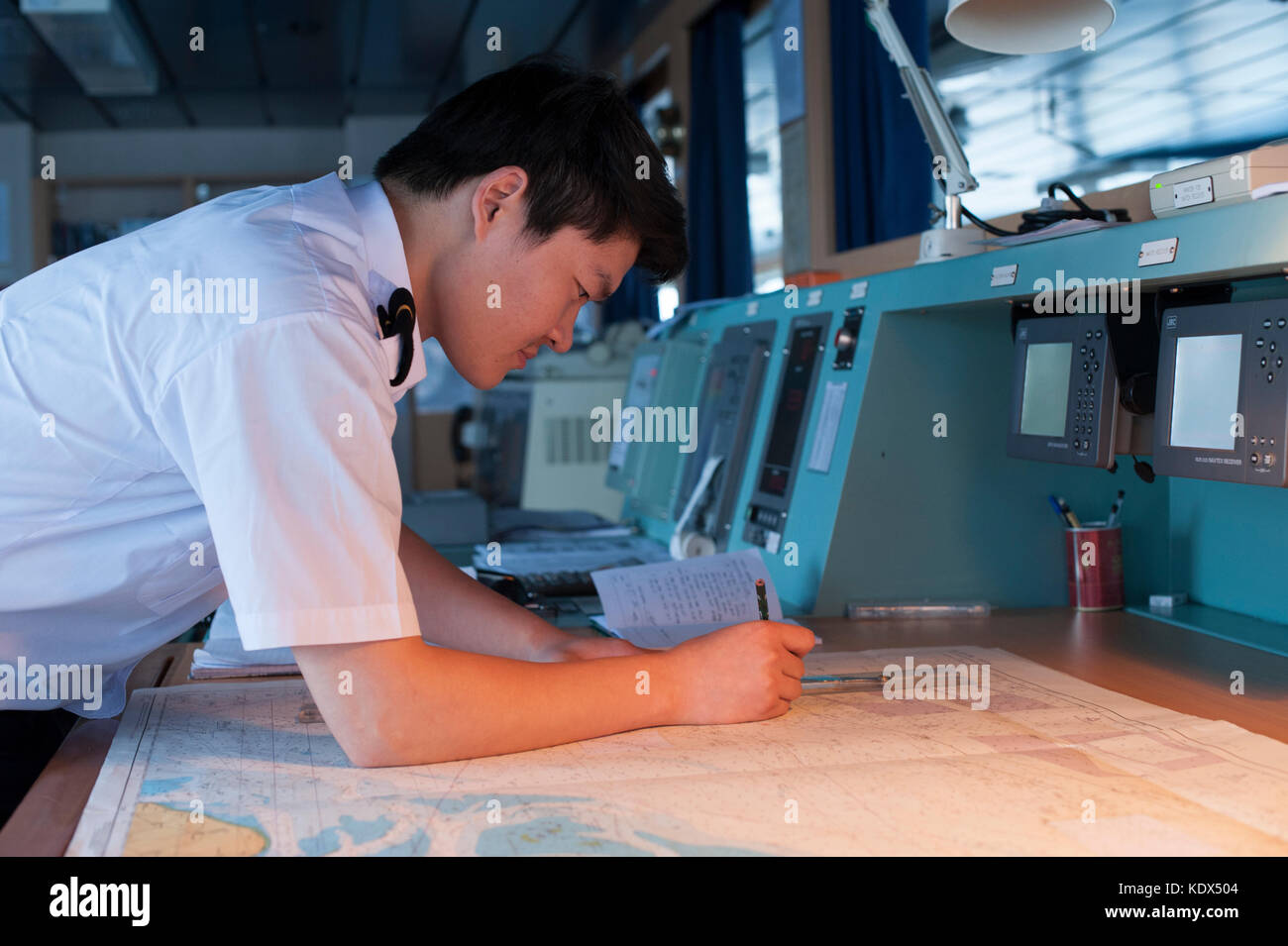 Navigation officer on a merchant ship plotting a course Stock Photo - Alamy
