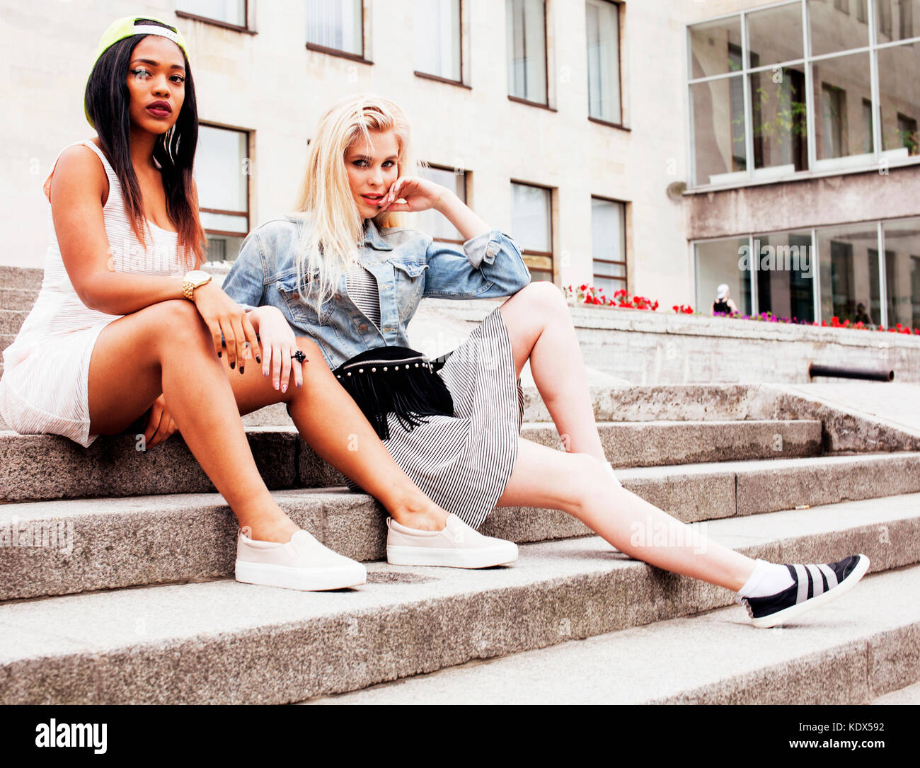 Two teenage girls infront of university building smiling, having Stock ...