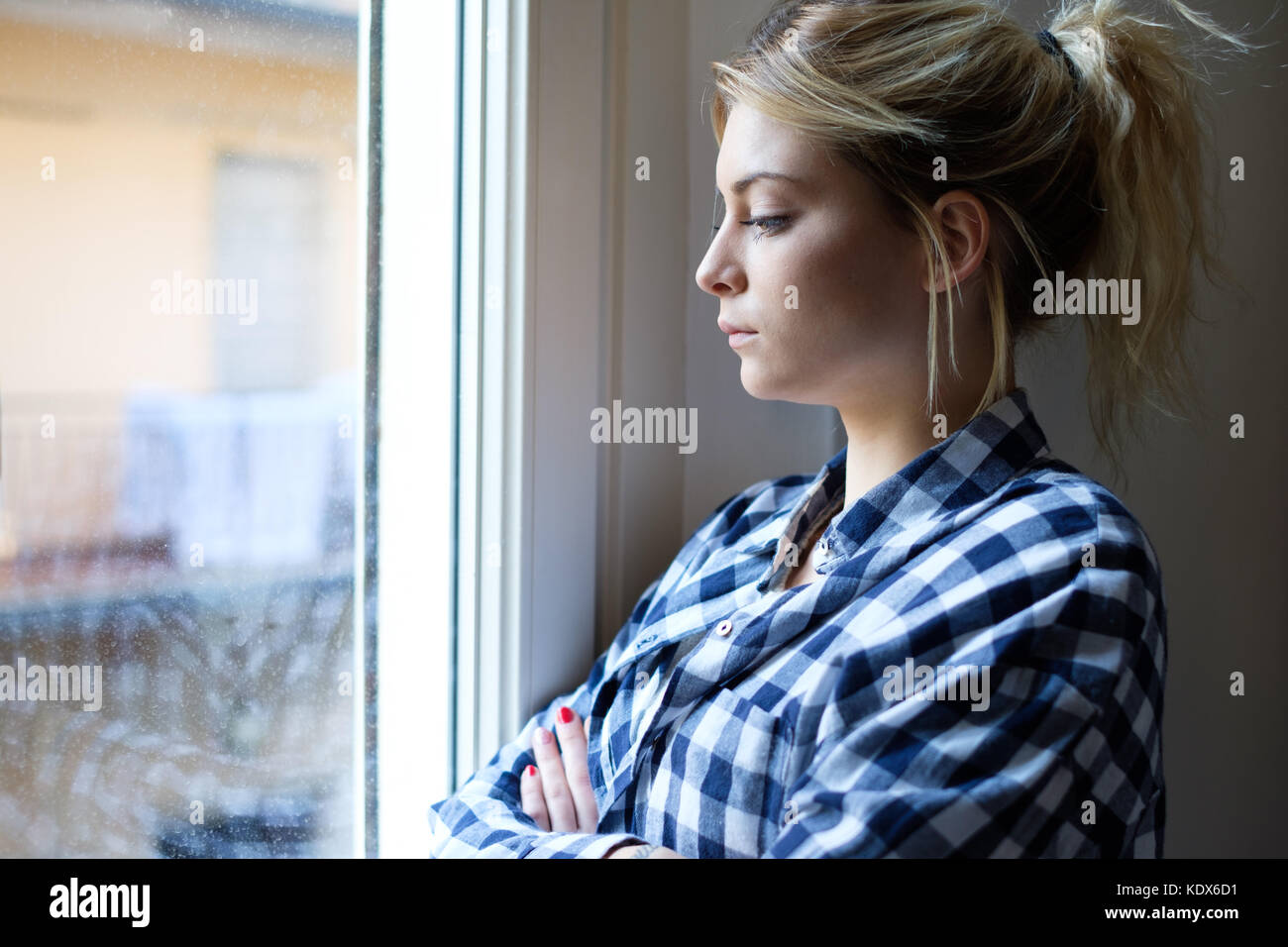 Sad teenager window hi-res stock photography and images - Alamy