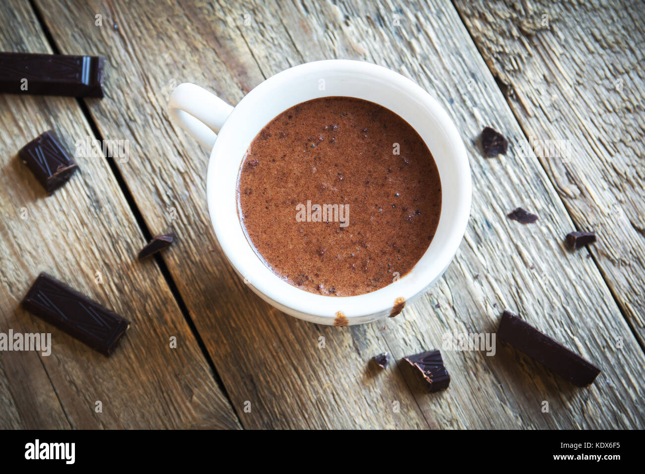 Hot Chocolate and chocolate pieces over rustic wooden background close ...