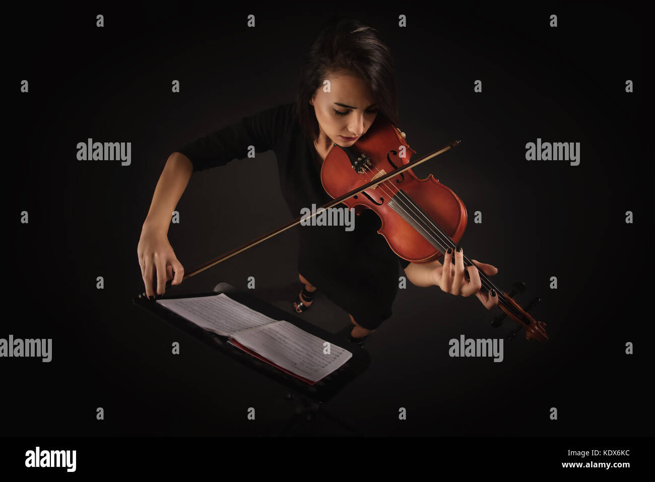 Beautiful Violinist Woman playing violin on black background Stock ...