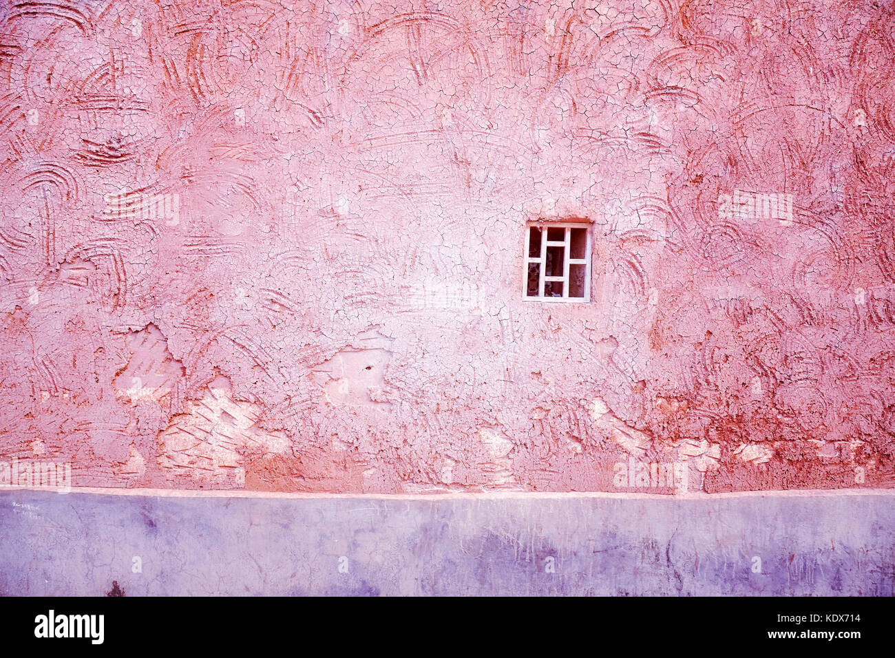 Old cracked clay wall with small window, color toning applied Stock ...