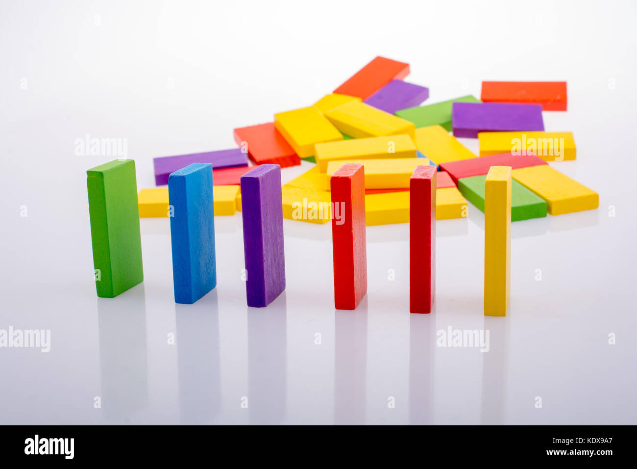 Colorful Domino Blocks in a line on a white background Stock Photo - Alamy