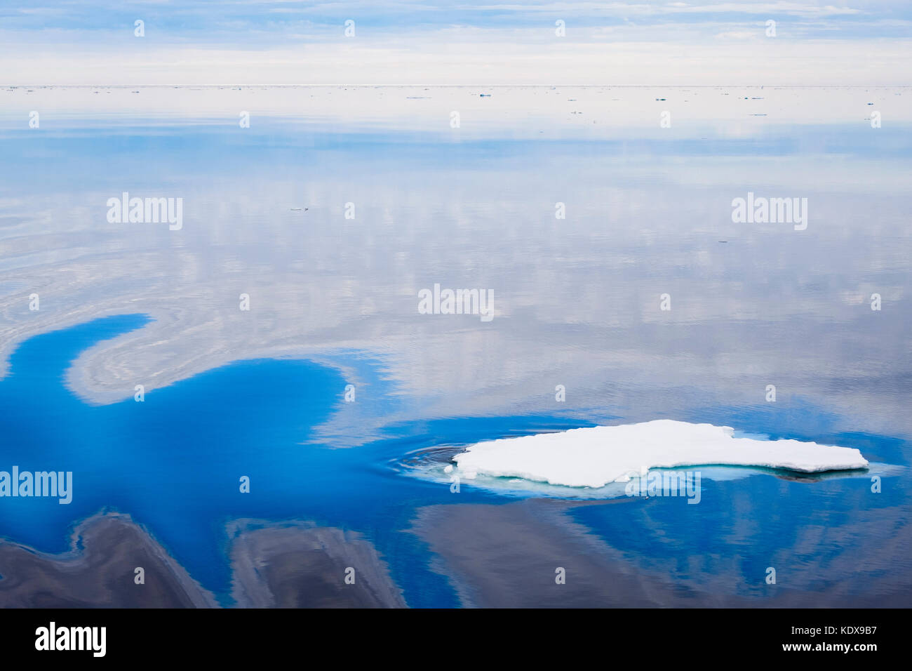 Sea water surface pattern with ice floating in boat wake on Spitsbergen ...