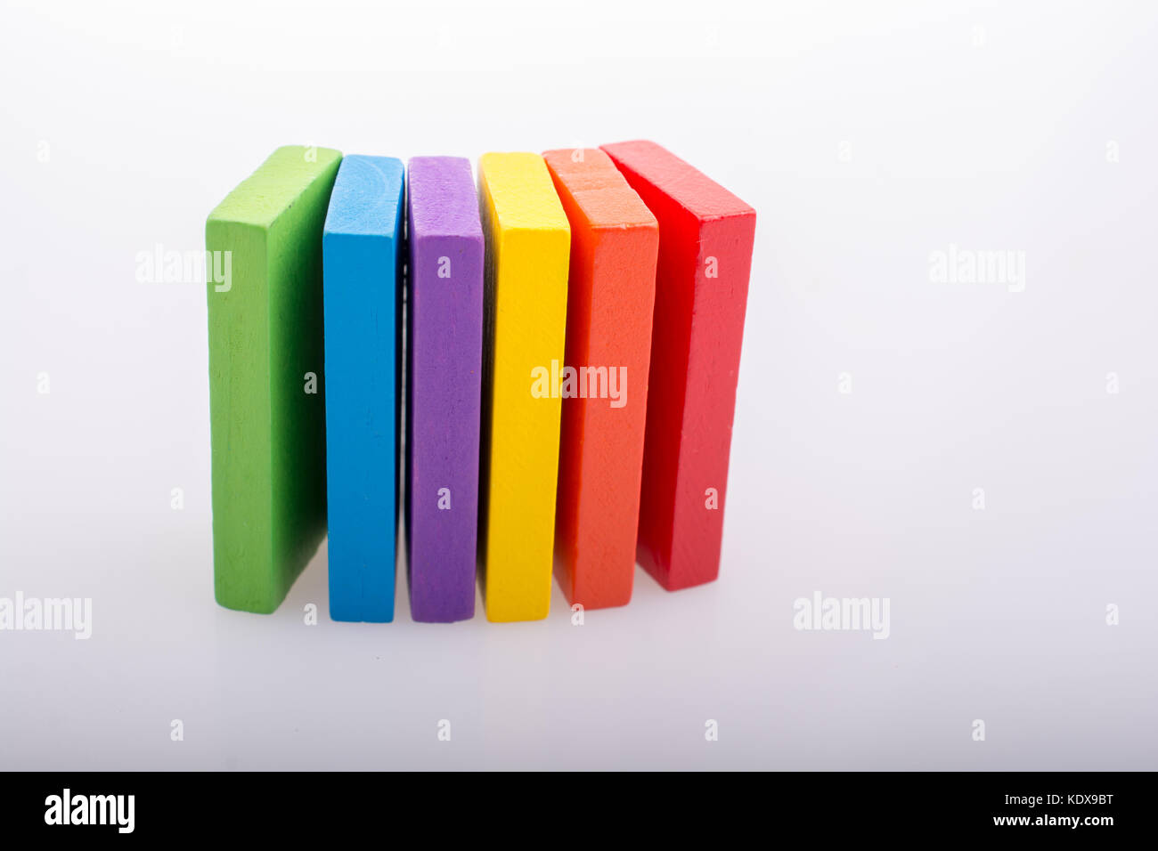 Colorful Domino Blocks in a line on a white background Stock Photo - Alamy