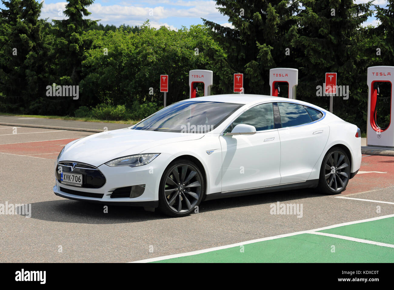 PAIMIO, FINLAND - JUNE 4, 2016: White Tesla Model S electric car leaves ...