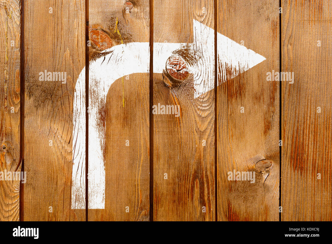 Row of tinted brown wooden boards with a driving direction sign Stock ...