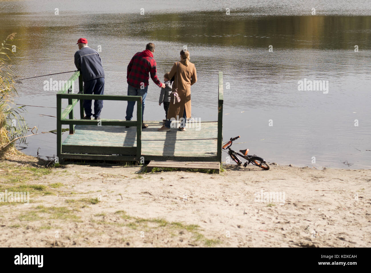 The family is resting near the lake Stock Photo - Alamy