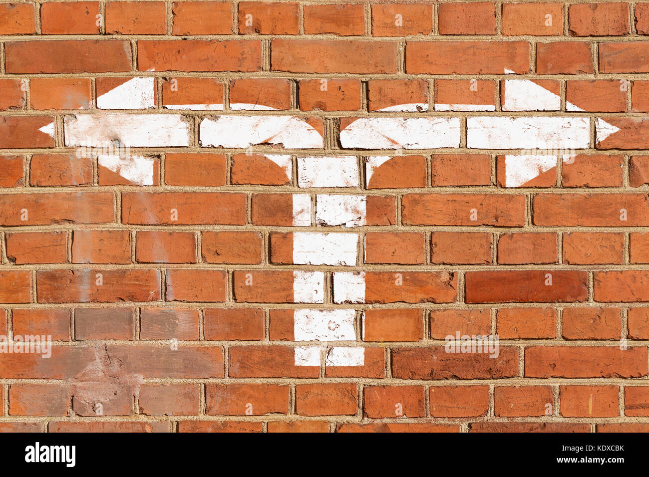 Brick wall with a driving direction sign Stock Photo - Alamy