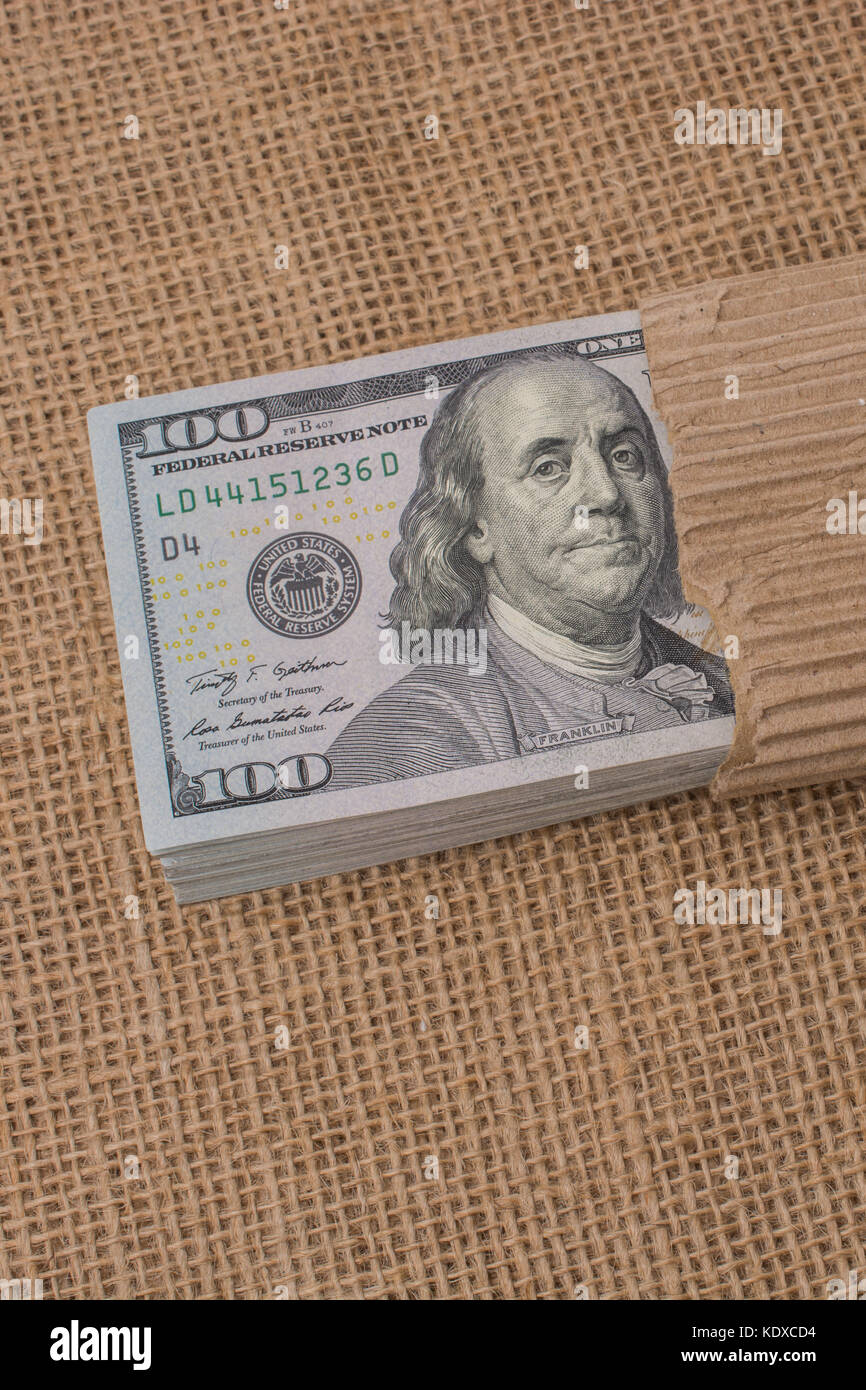 Banknote bundle of US dollar placed on a linen canvas Stock Photo - Alamy