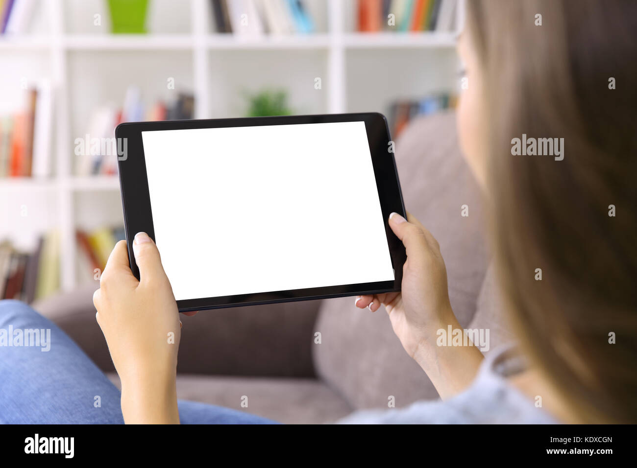 Woman watching media content showing a blank tablet screen sitting on a ...