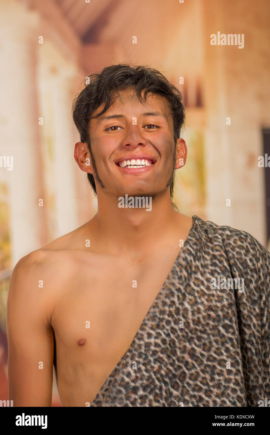Close up of funny prehistoric man smiling to the camera in a blurred ...