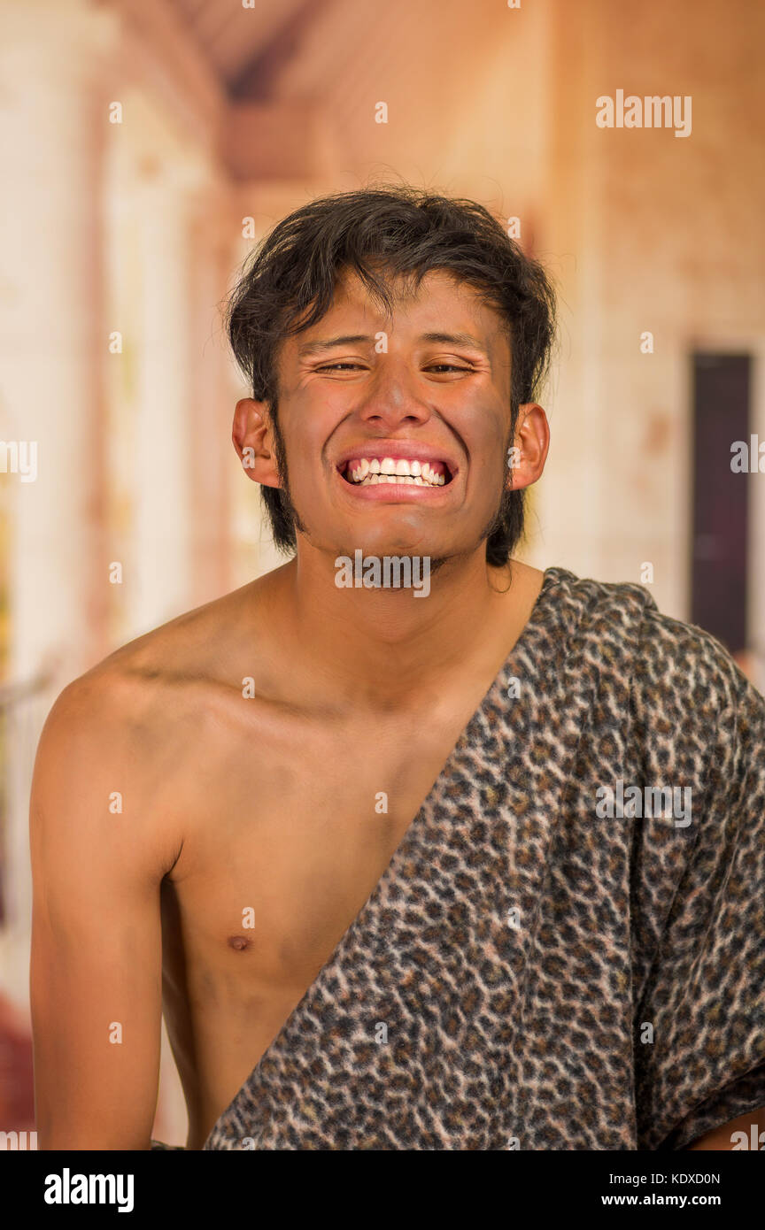 Close up of funny prehistoric man smiling to the camera in a blurred ...