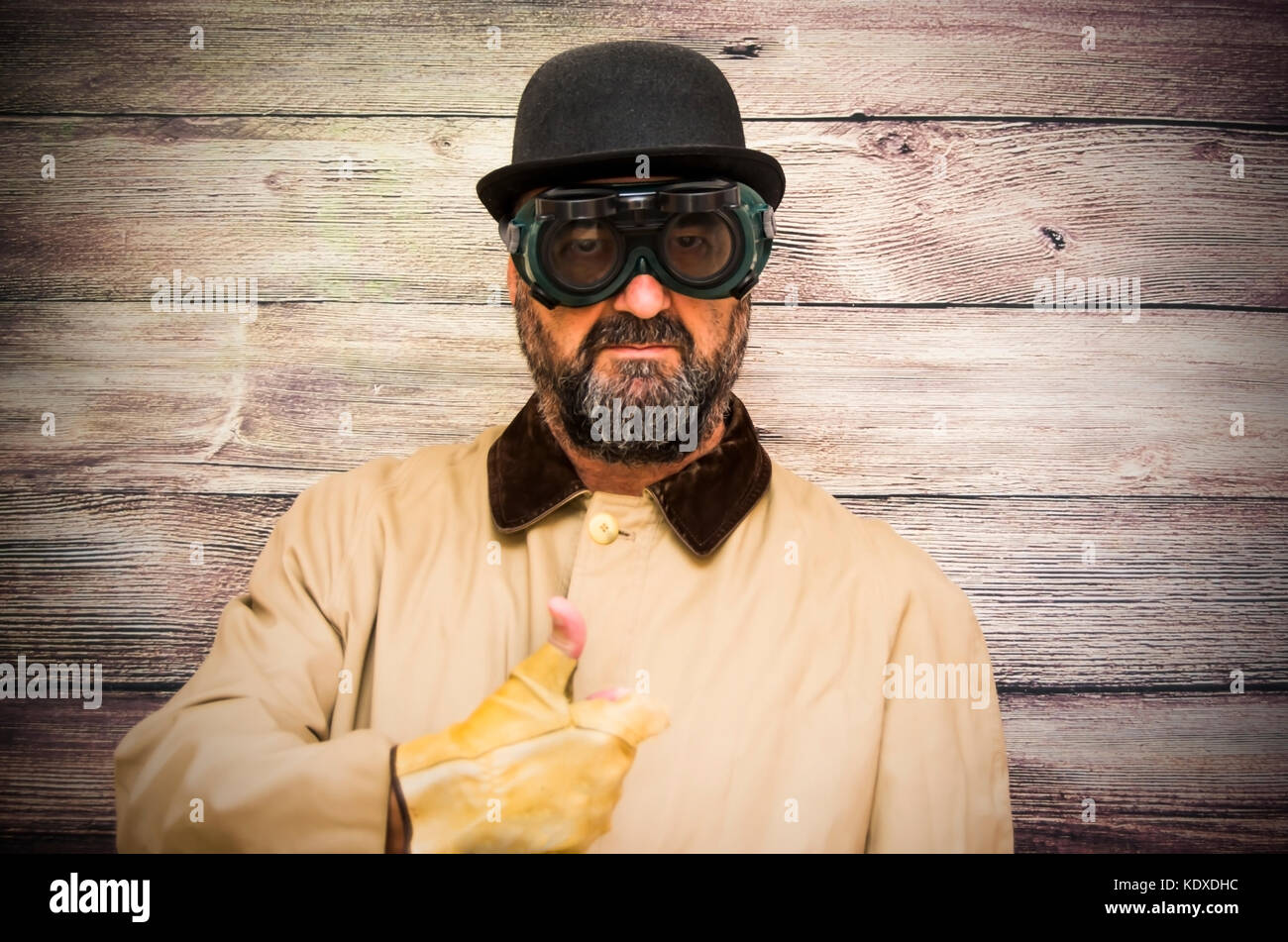 Man with beard, bowler, raincoat and some strange futuristic glasses ...