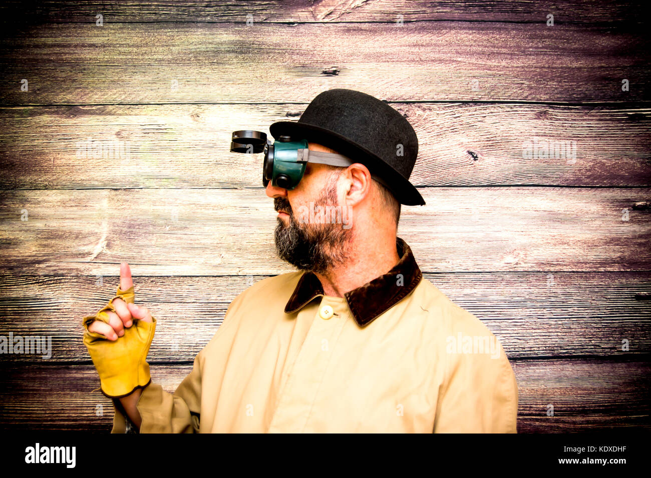 Man with beard, bowler, raincoat and some strange futuristic glasses ...