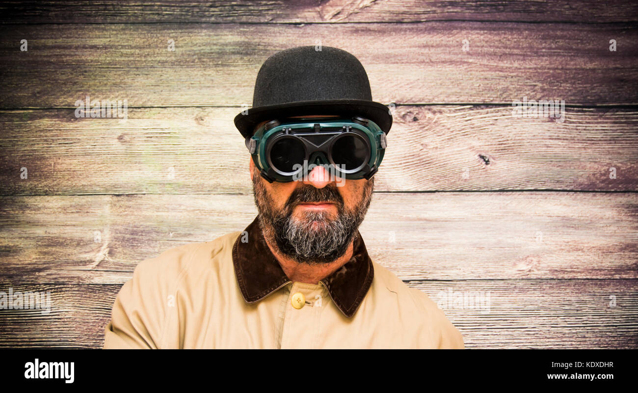 Man with beard, bowler, raincoat and some strange futuristic glasses ...
