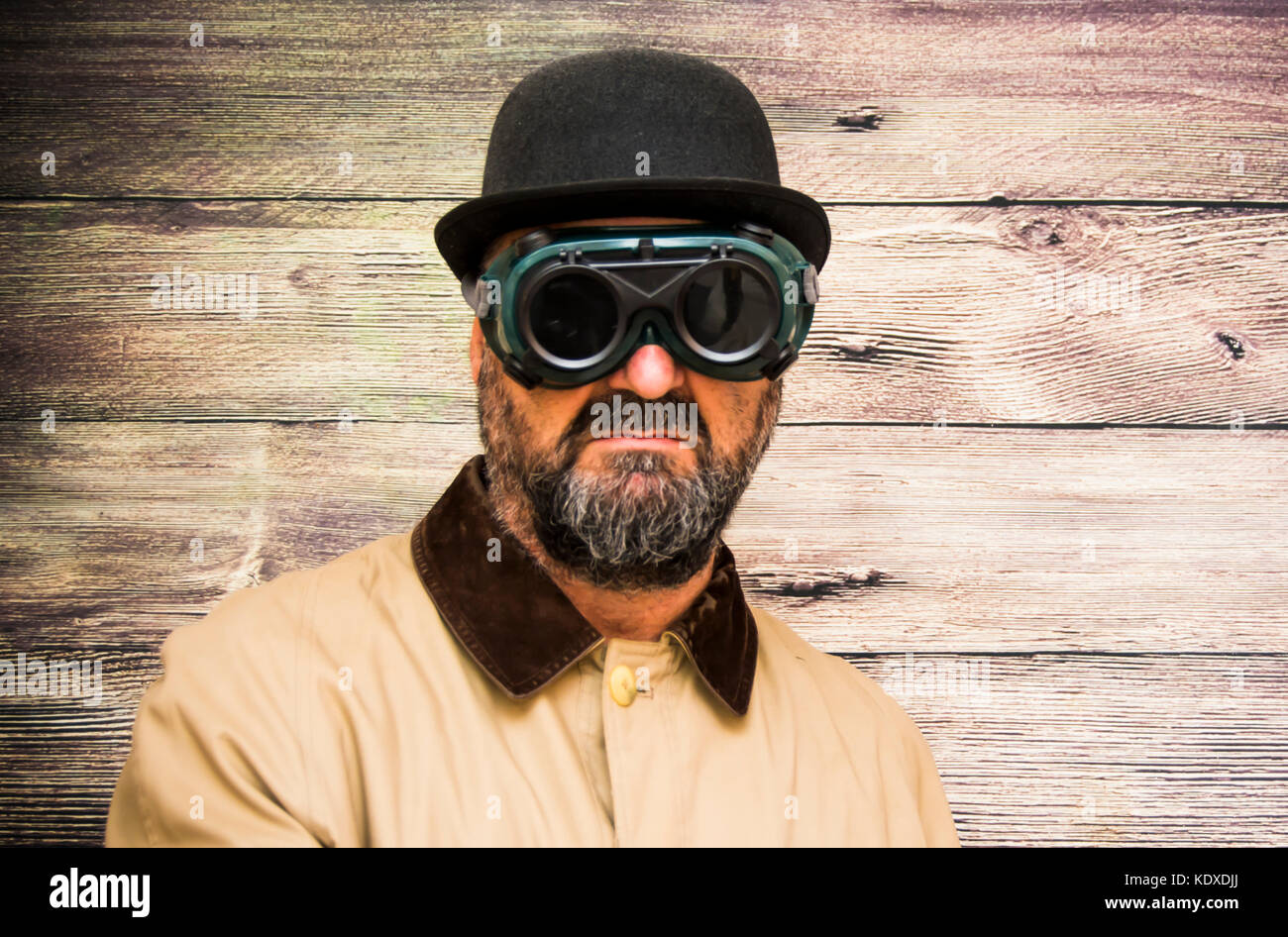Man with beard, bowler, raincoat and some strange futuristic glasses ...