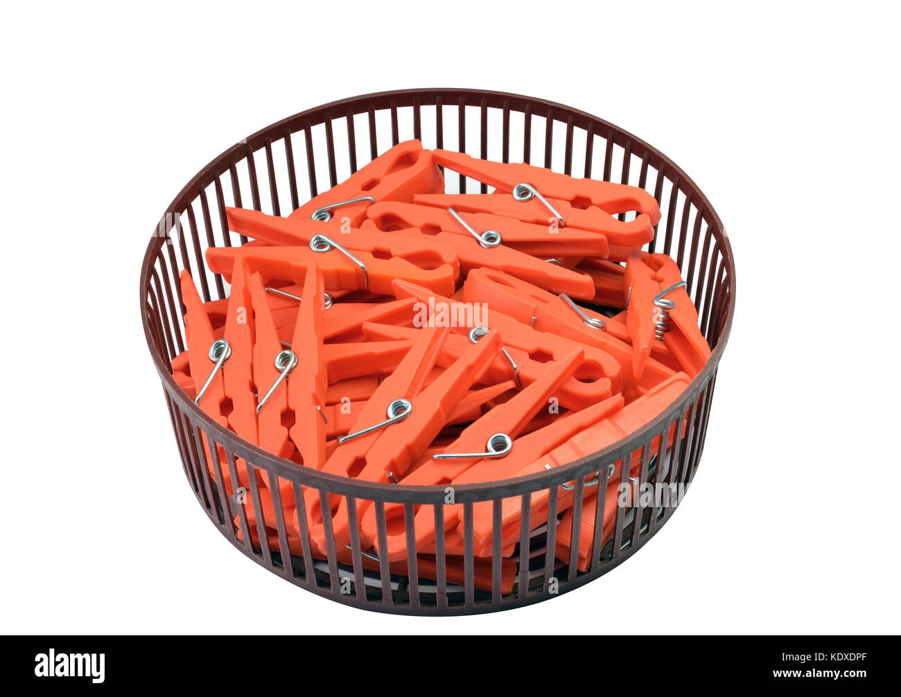 Pile of clothespins in a plastic basket isolated on white background ...