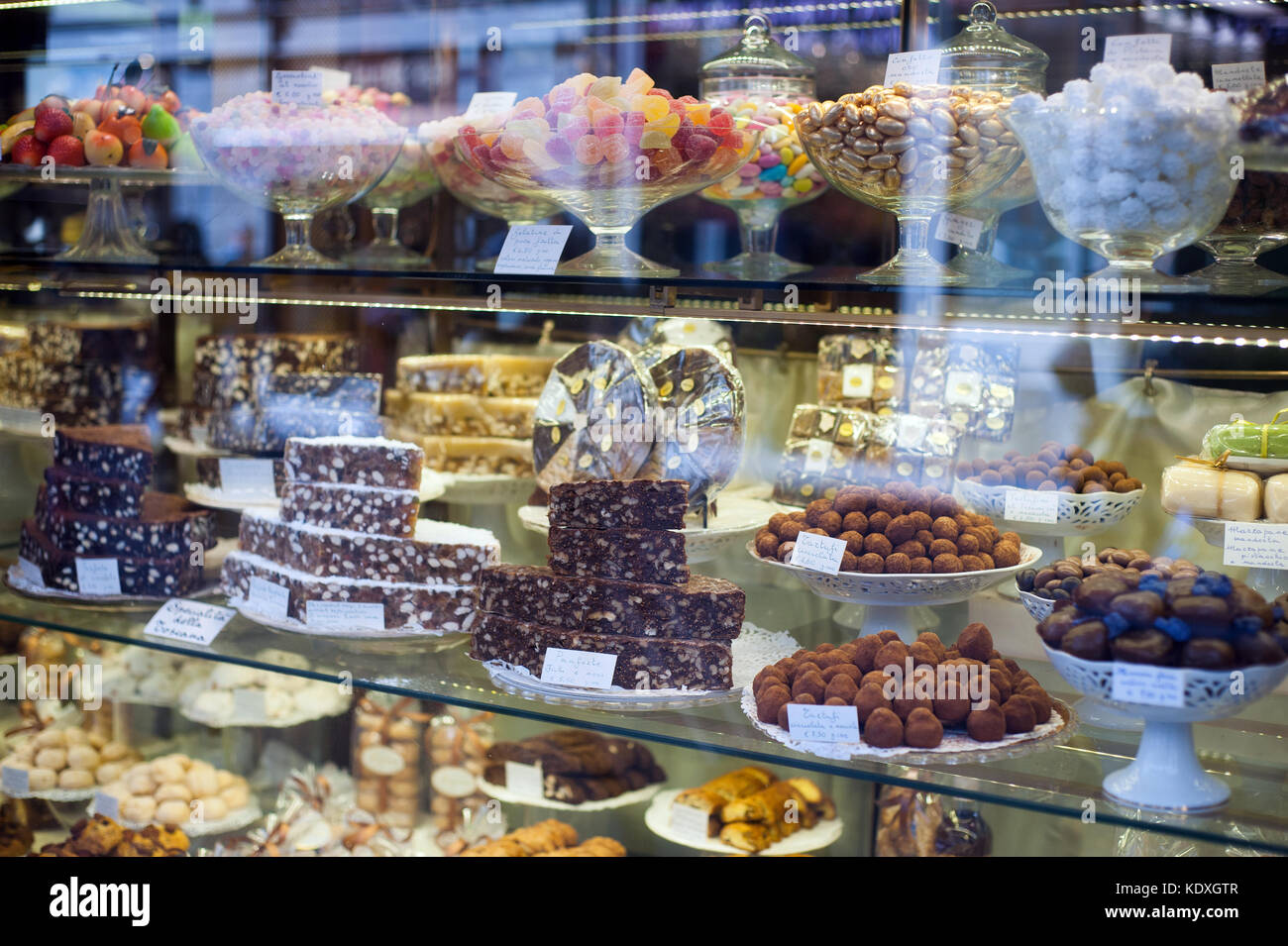 Sweets on display through window shop Stock Photo - Alamy