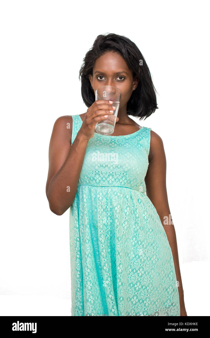 Woman drinking water looking at camera Stock Photo - Alamy