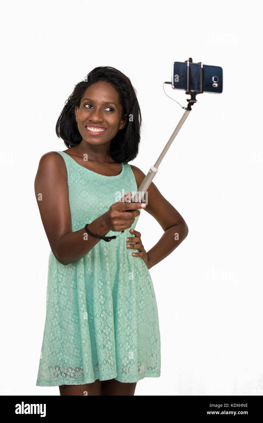 Woman using selfie stick Stock Photo - Alamy