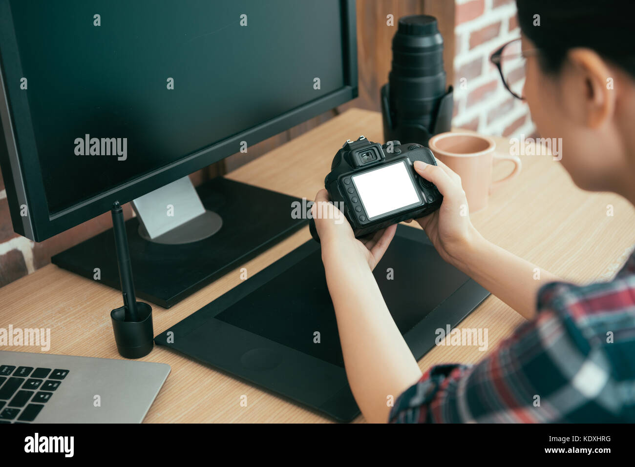 closeup back view of female business photographer holding professional ...