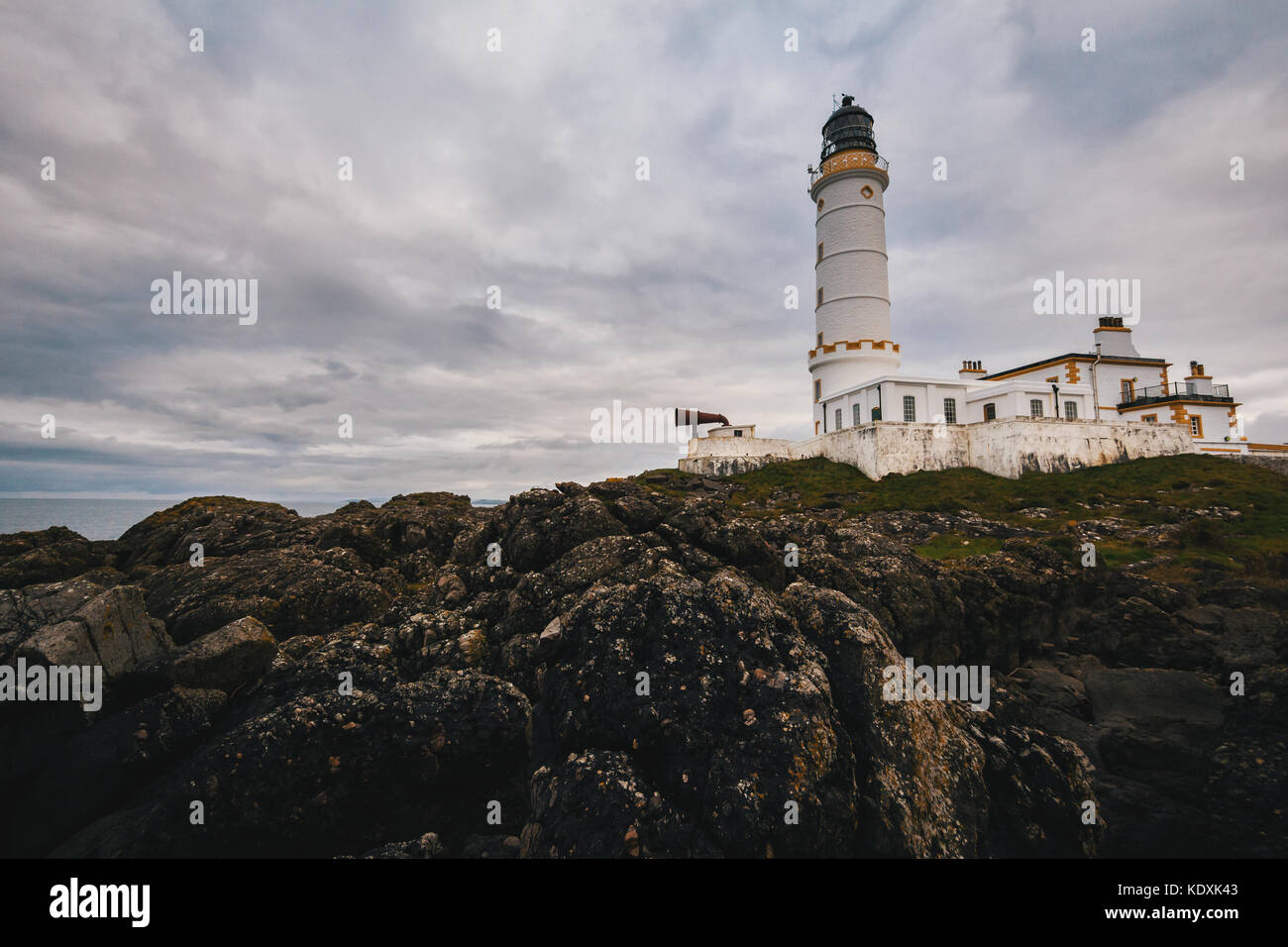 Old lighthouse on the rock coast of sea Stock Photo - Alamy