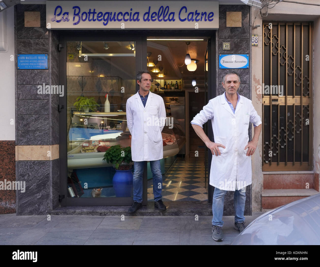 A view of butchers outside their shop on the street in Monreale. From a ...