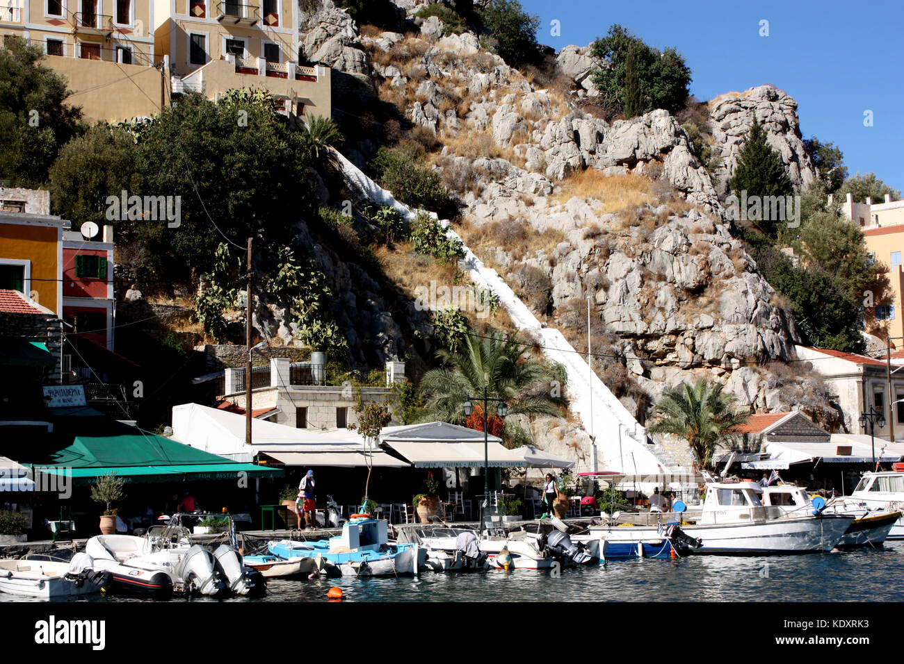 Houses and boats in the Harani Bay area of Symi Town, Dodecanese ...