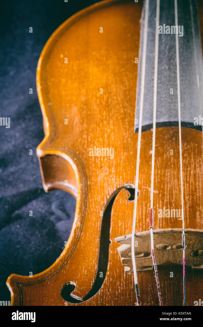 Vertically photo of the used old violin. Edited as a vintage photo with ...