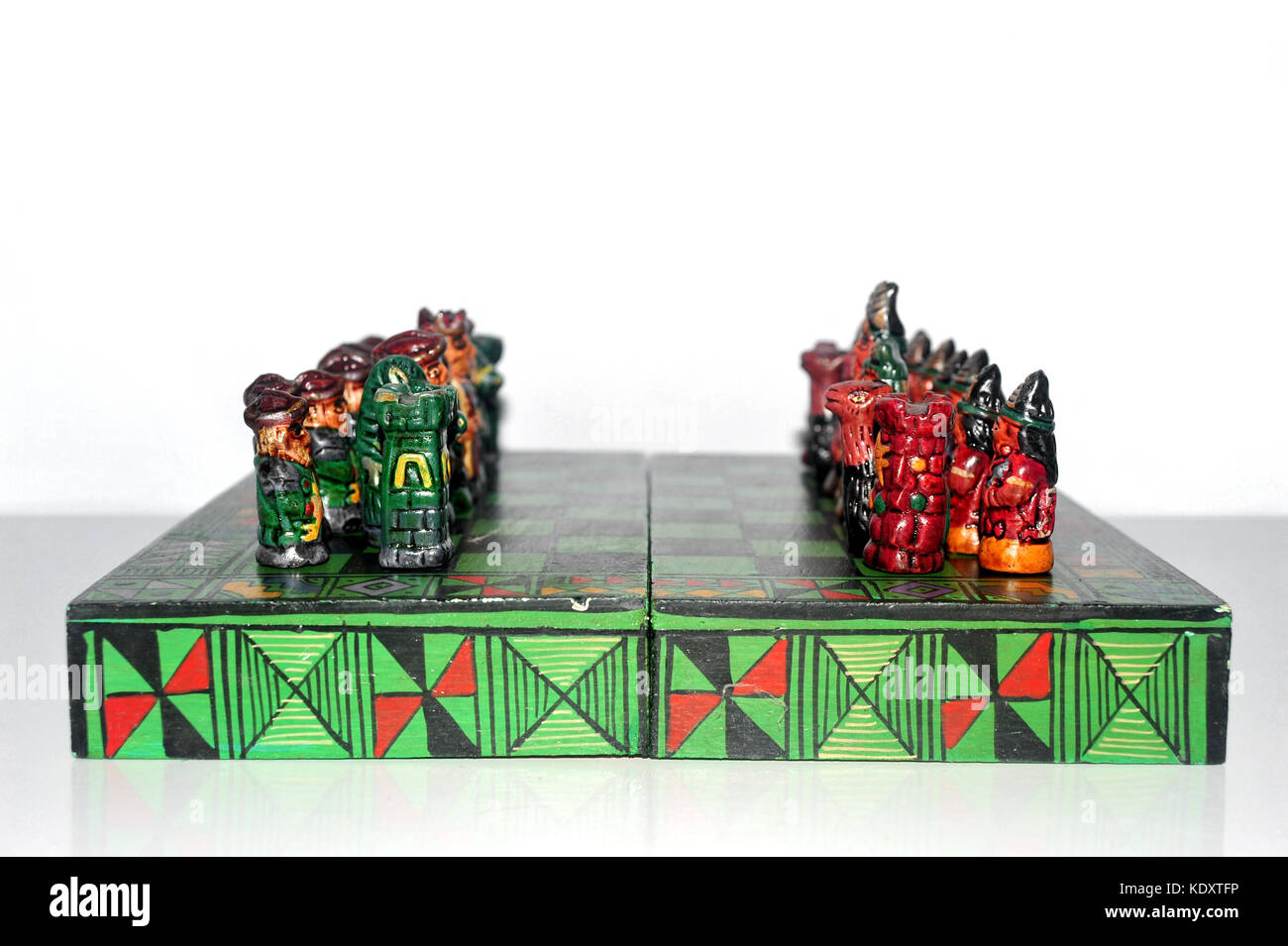 A side view of a decorative chess board photographed against a white ...