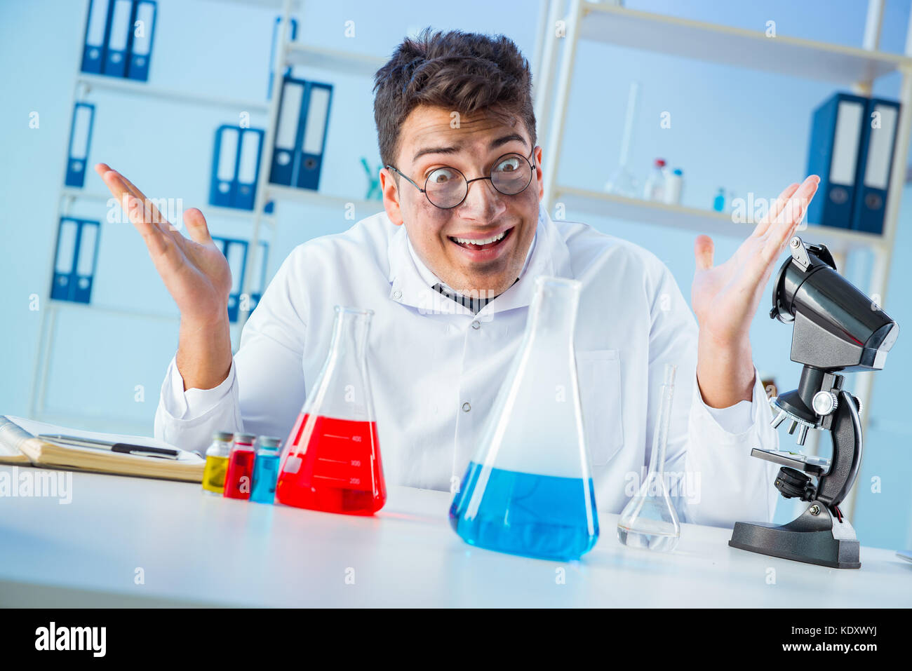 Funny mad chemist working in a laboratory Stock Photo - Alamy