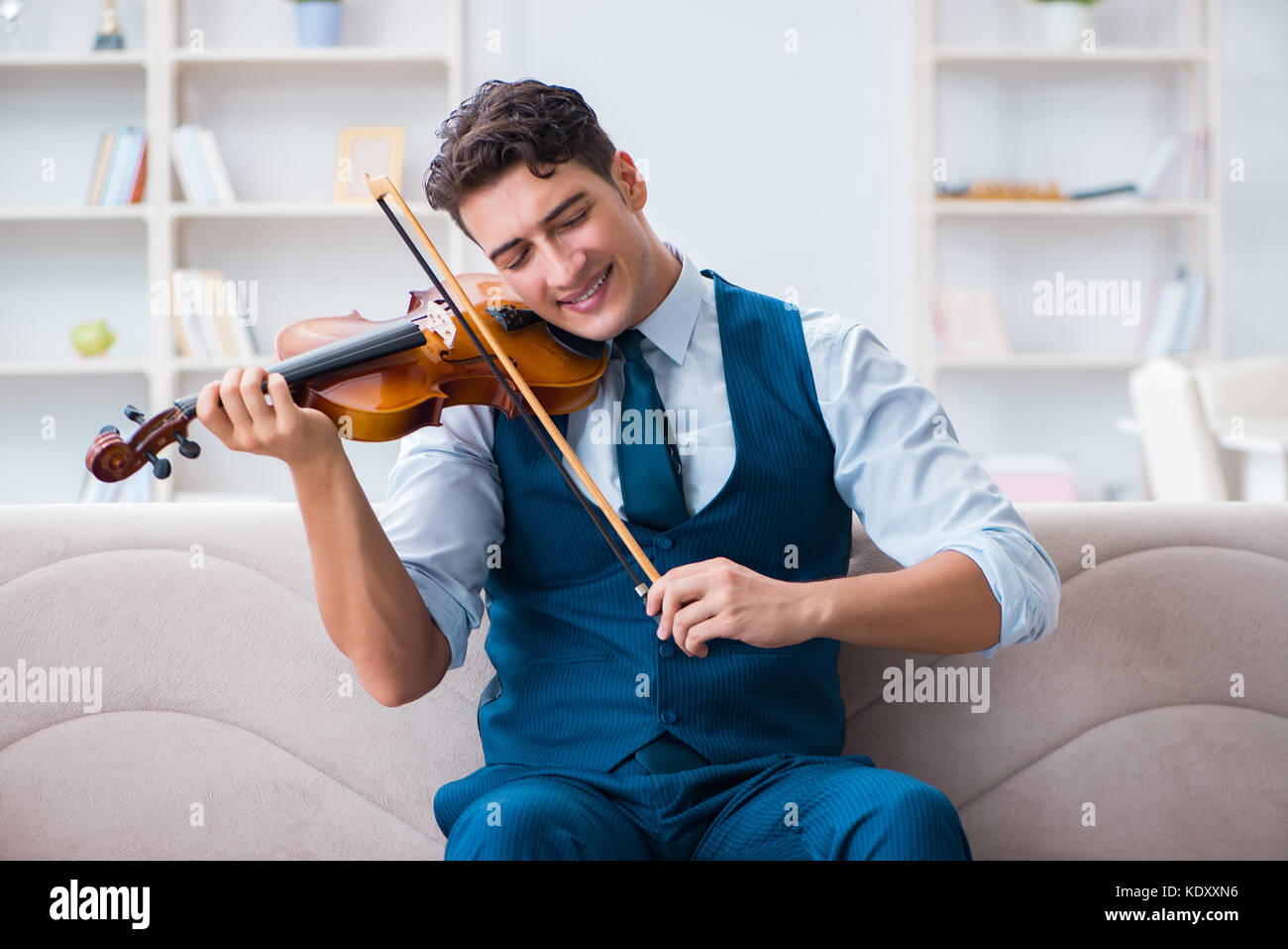 Young musician man practicing playing violin at home Stock Photo - Alamy