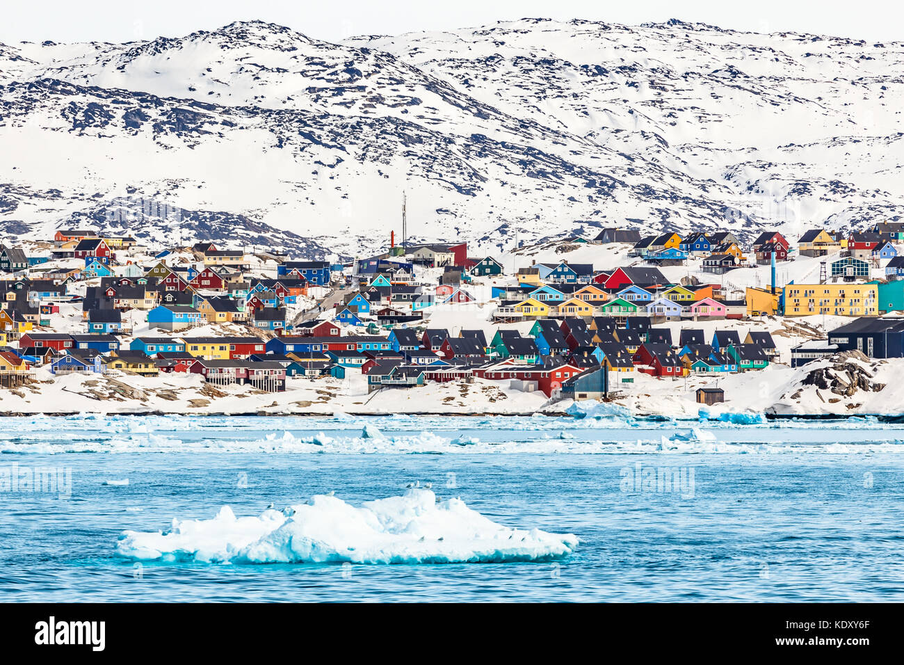 Arctic city panorama with colorful Inuit houses on the rocky hills ...