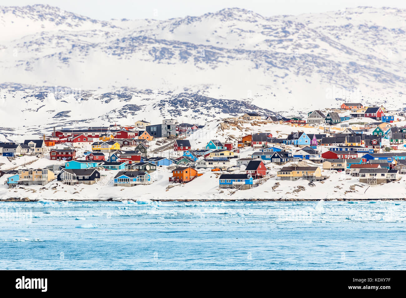 Arctic city panorama with colorful Inuit houses on the rocky hills ...