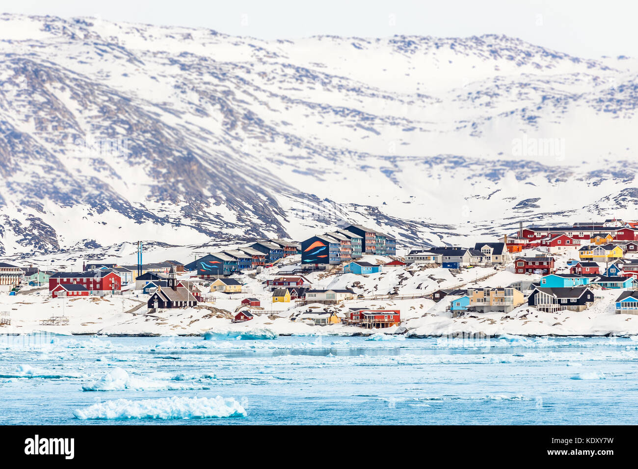 Arctic city panorama with colorful Inuit houses on the rocky hills ...