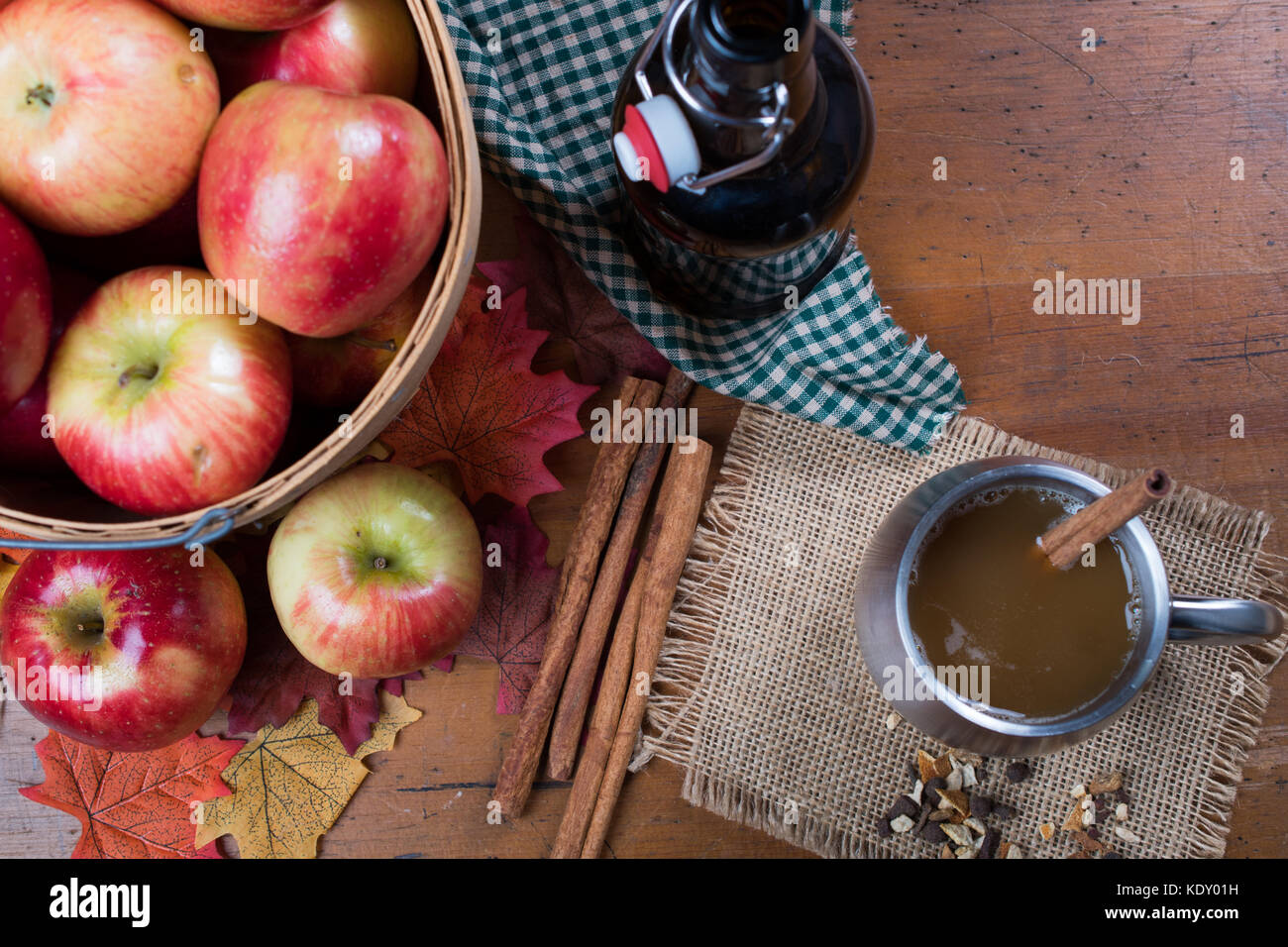 Top view of apple cider in a cup next to a basket of apples Stock Photo ...