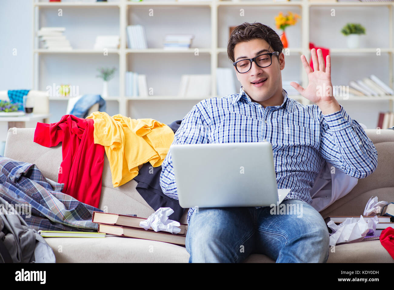 Young man working studying in messy room Stock Photo - Alamy
